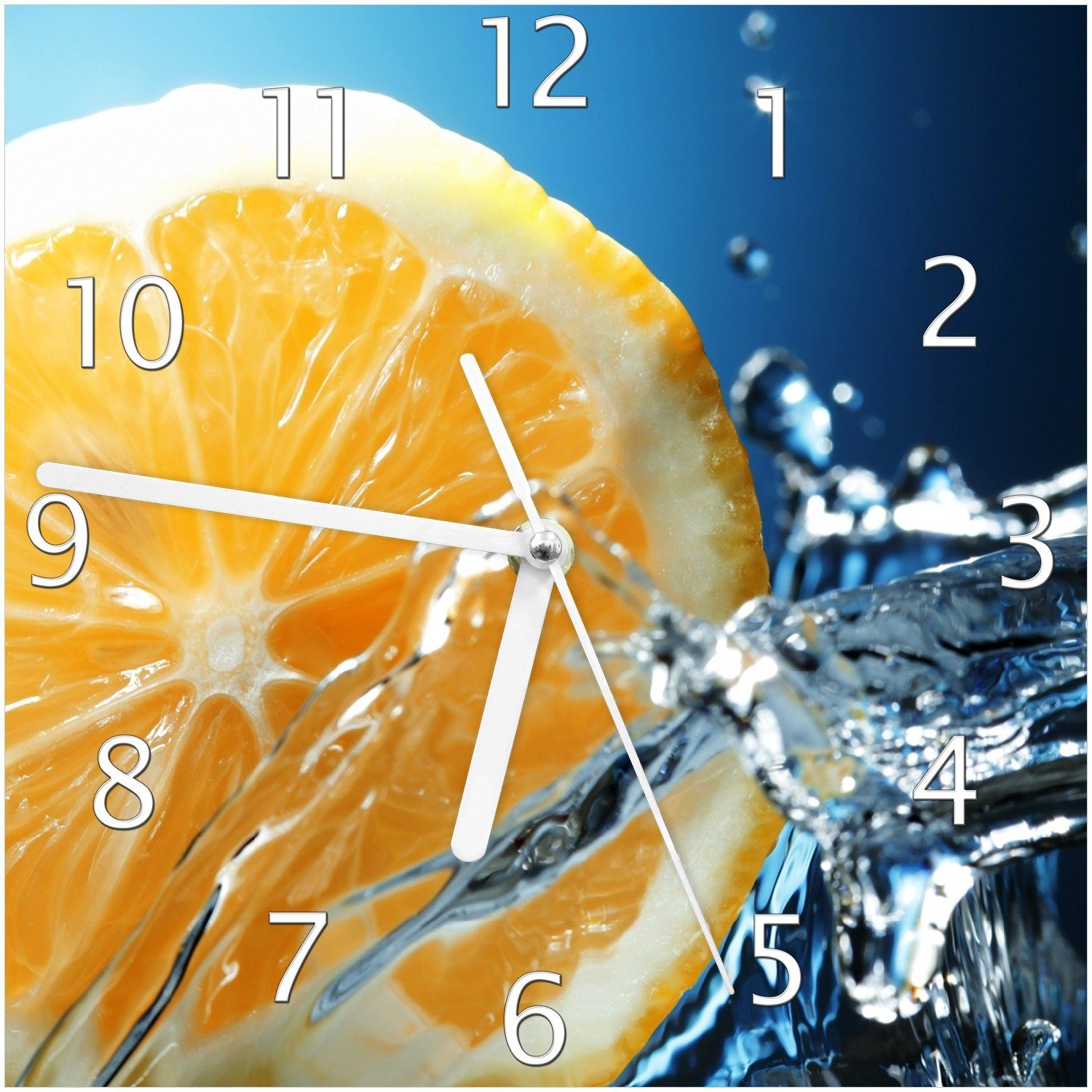 Wallario Wanduhr Orange In Spritzigem Wasser Vor Blauem Hintergrund